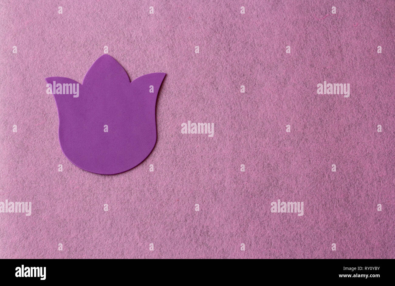 Violet flower made of soft material on a pink rag background Stock ...