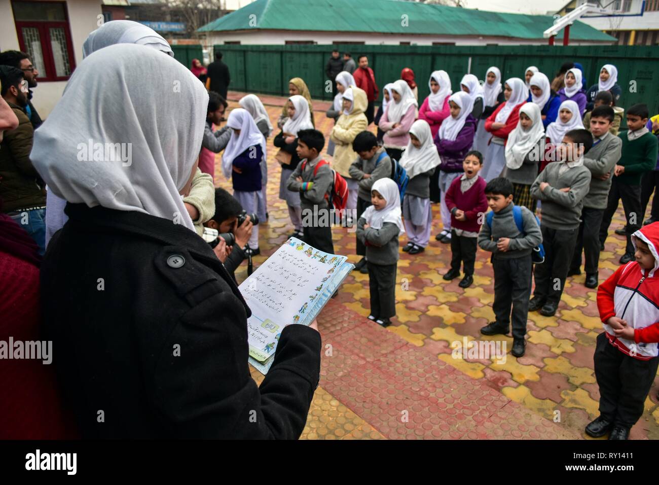 Kashmiri students attend the morning assembly in their school premises on the first day of the ...