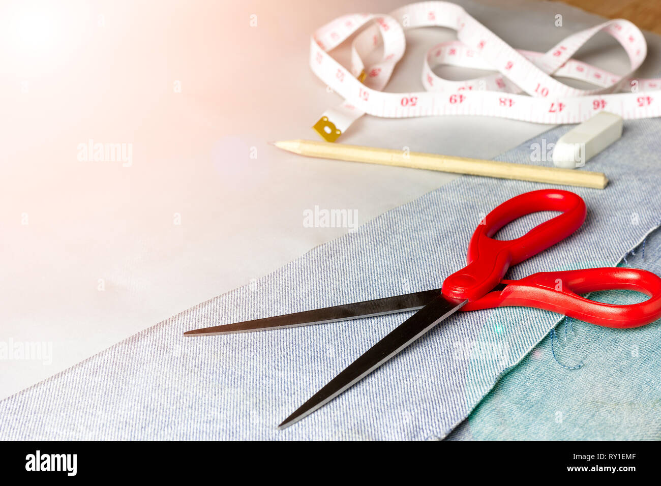 Equipment for jeans fabric cutting on brown wood background Stock Photo ...