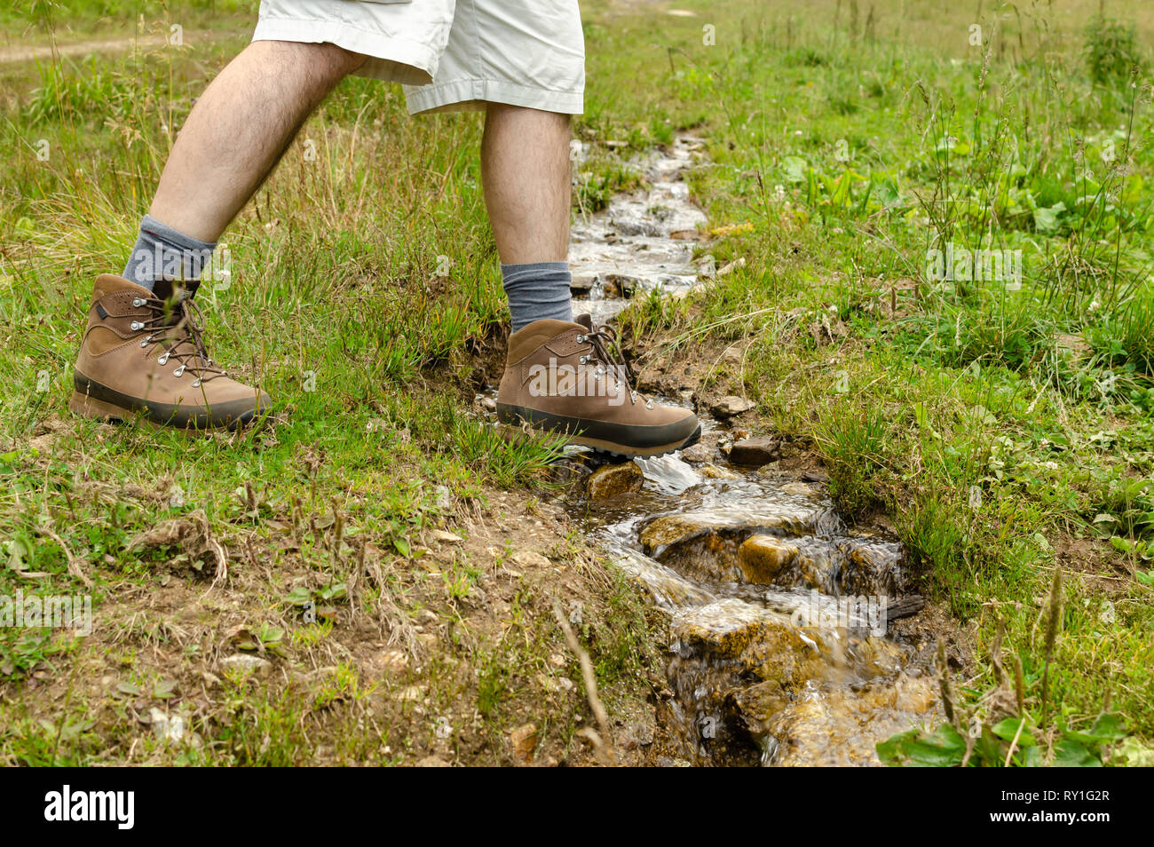 Hiker's leather shoe while crossing a brook Stock Photo - Alamy