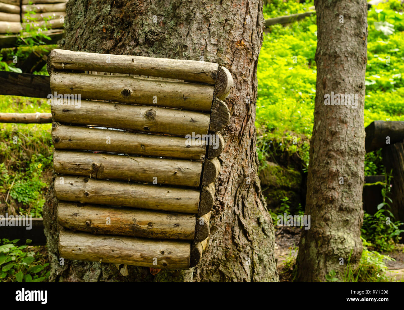 Bin made of wood hooked on a tree Stock Photo - Alamy