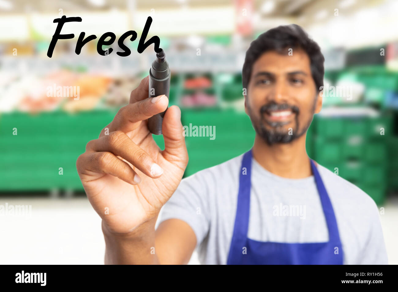 Close-up or indian man grocery store or supermarket employee writing ...