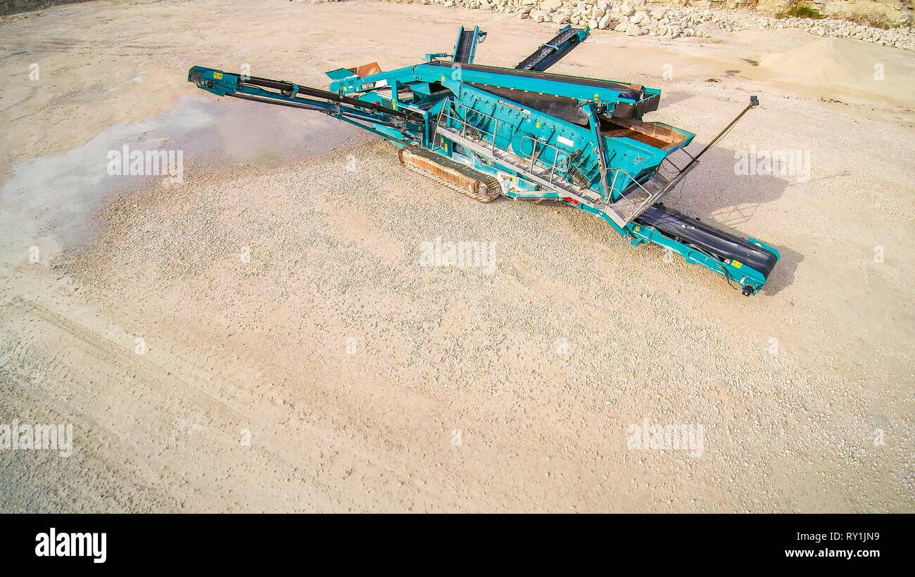 The green big limestone crusher machine that is in the middle of the ...