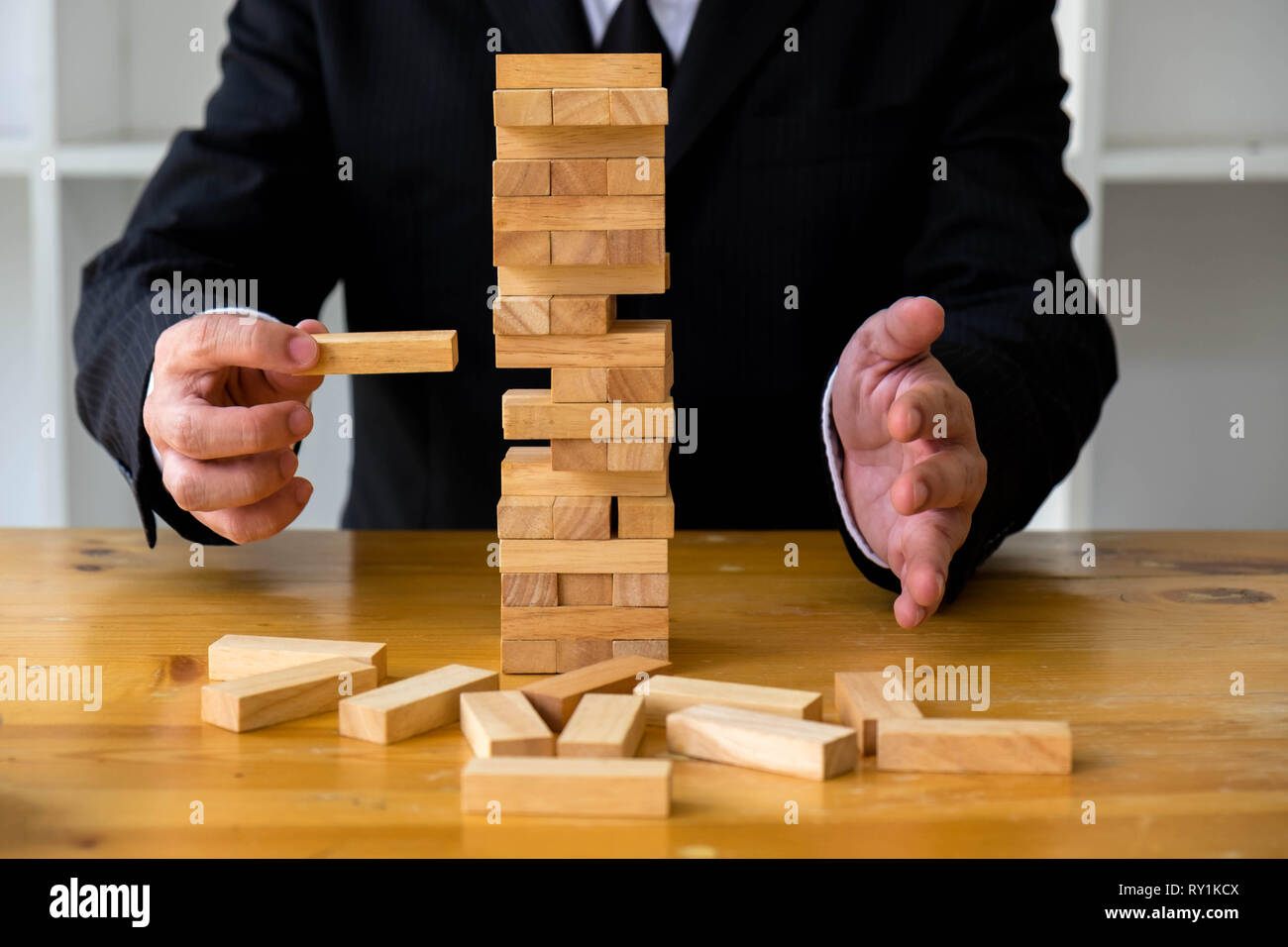 Businessmen picking dominoe blocks to fill the missing dominos and ...