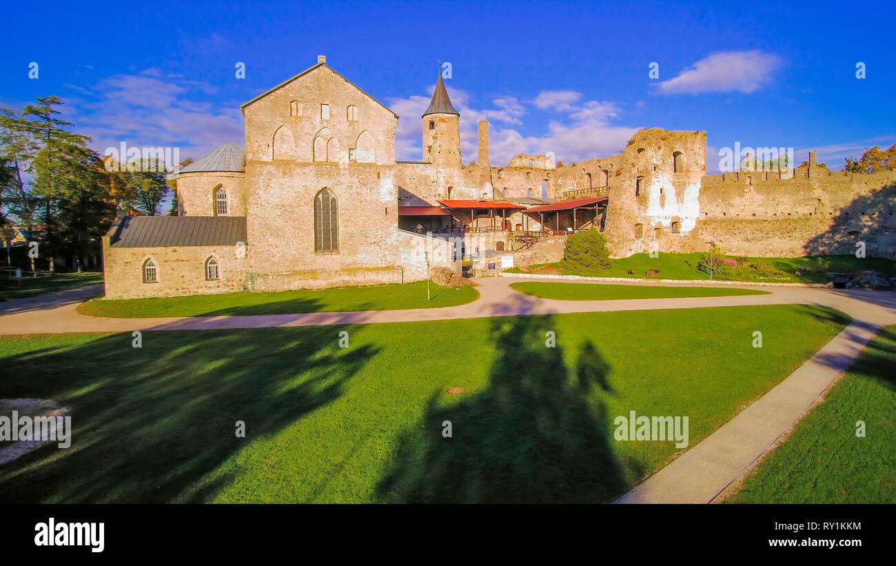 The old ruined Haapsalu castle in Estonia. It has a green grassland ...