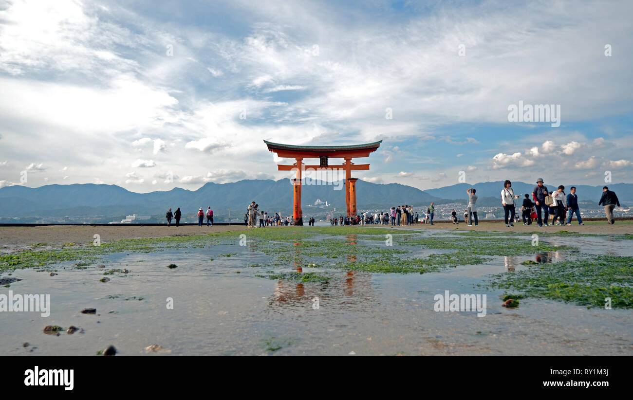 A traditional Itsukushima Shrine gate sits on a beach on the Japanese ...