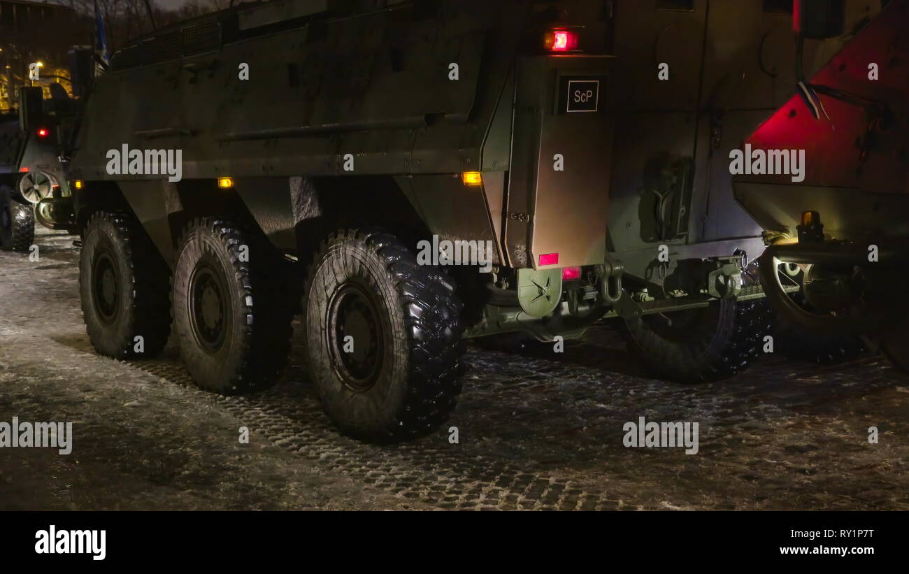 The big military tanks during a night event seen the big tires and ...