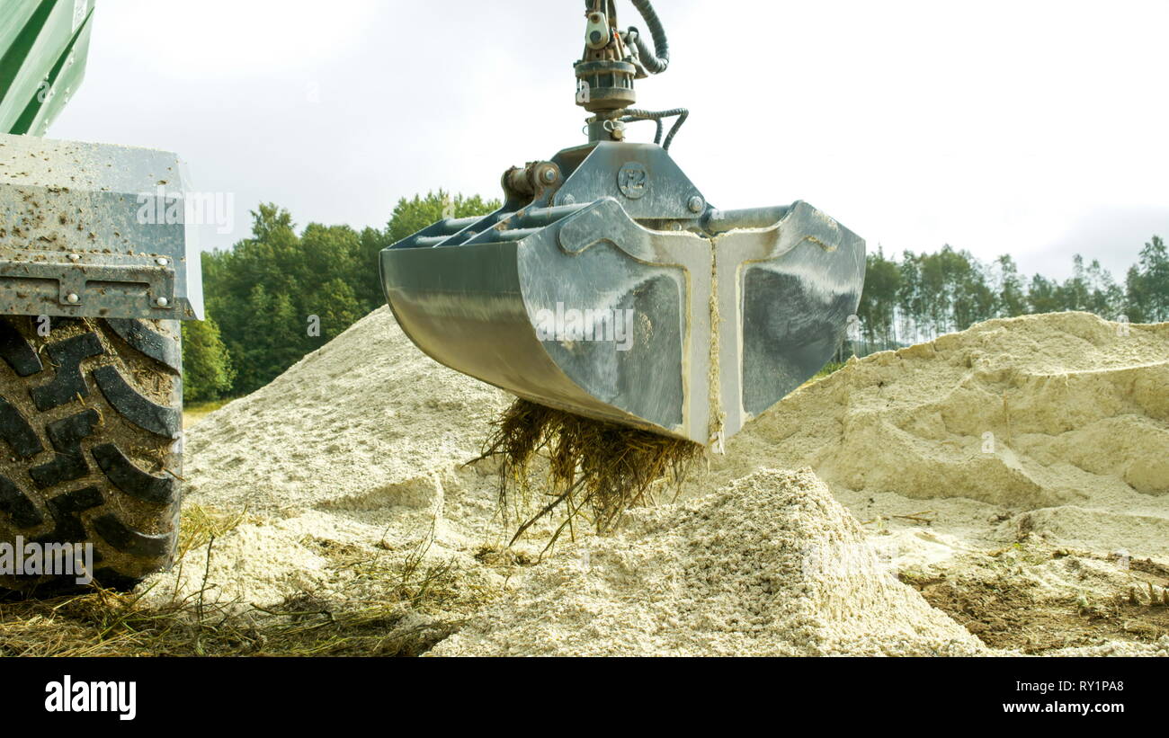 The big backhoe getting some powdered limestones on a mining site in a ...