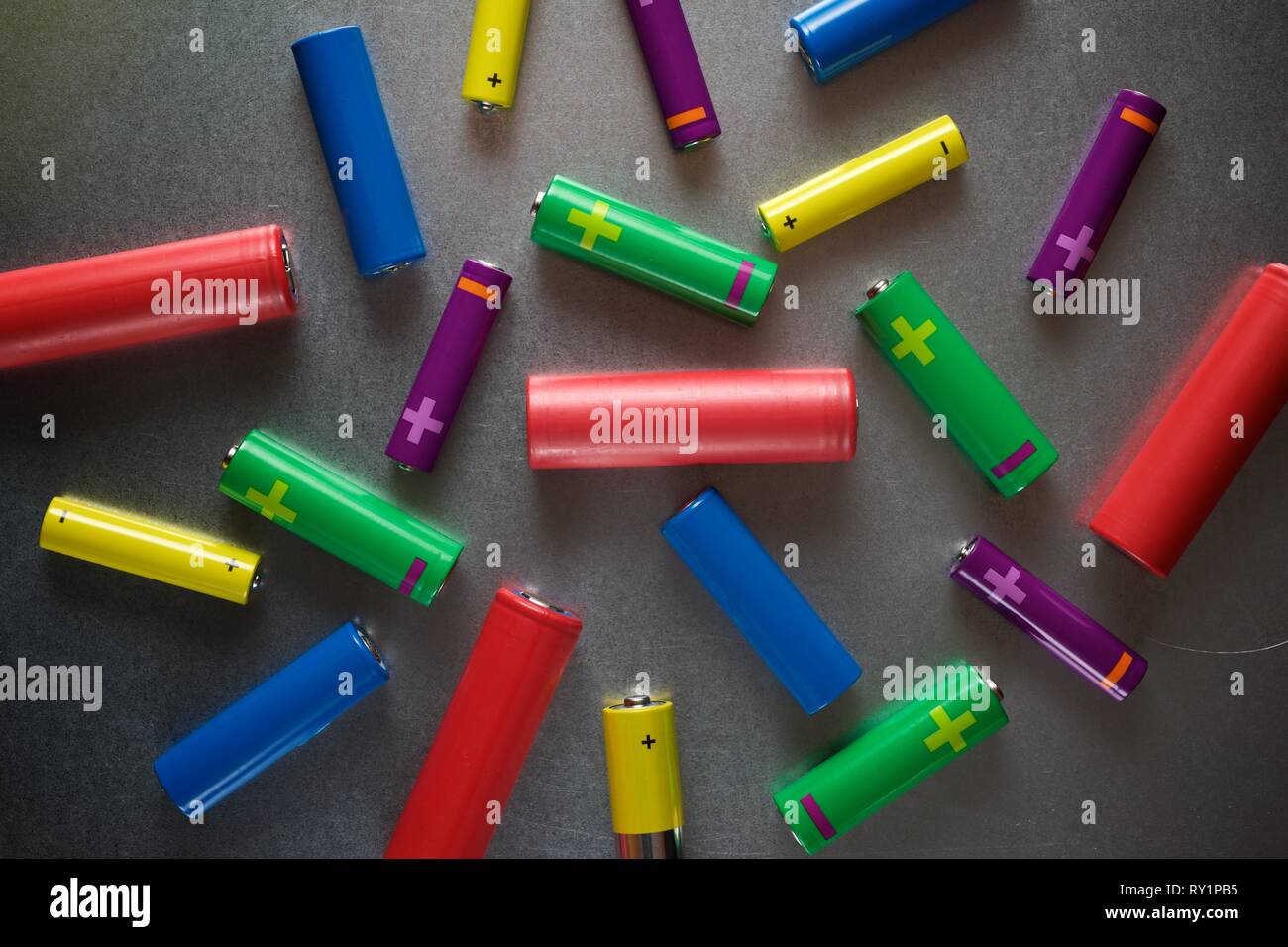 Many batteries on a metal table Stock Photo - Alamy