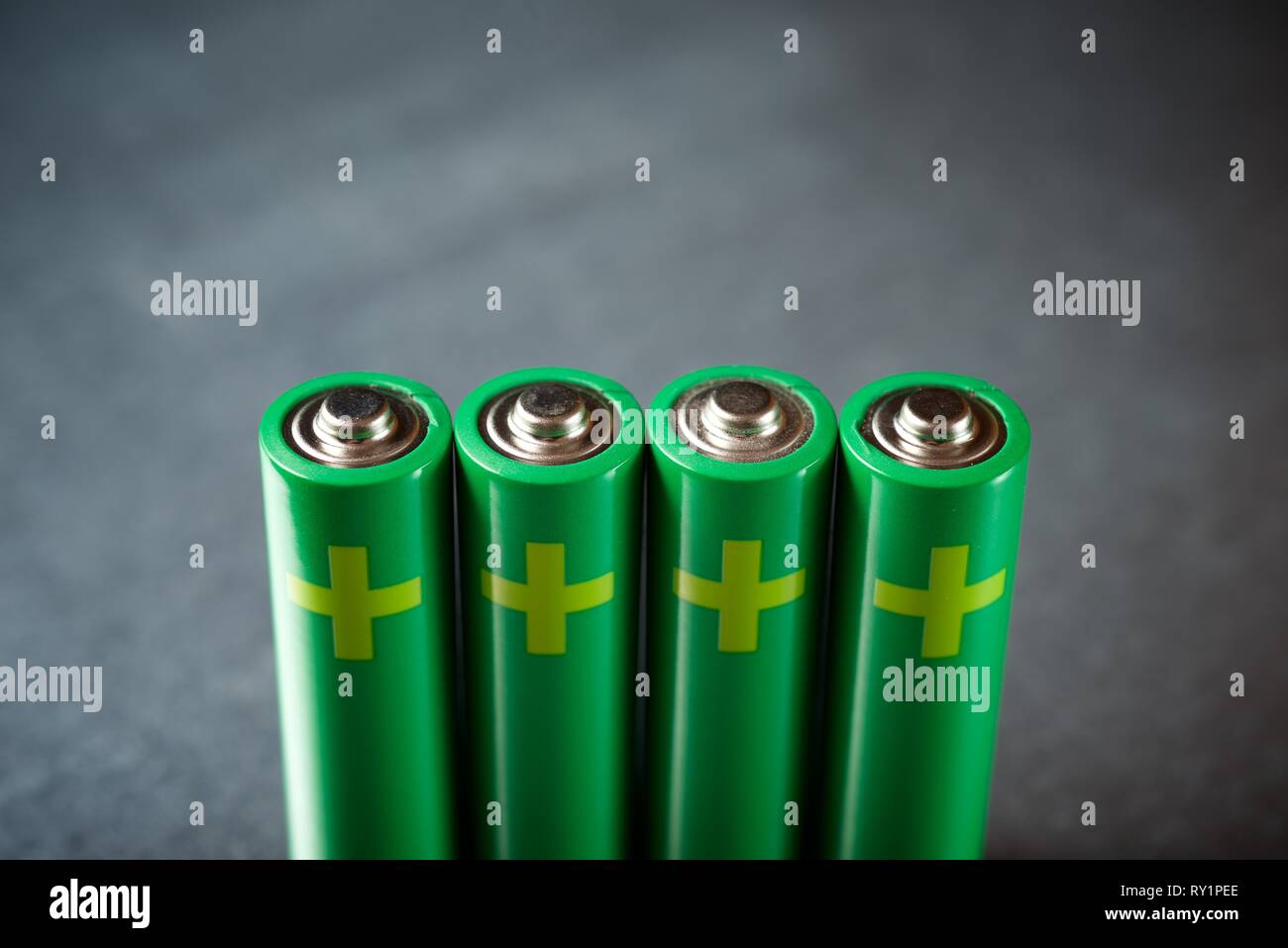 Four batteries on a metal table Stock Photo - Alamy