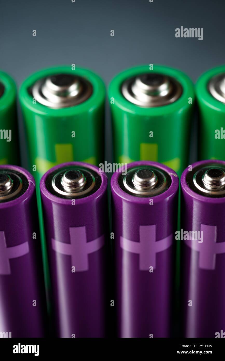 Eight batteries on a metal table Stock Photo - Alamy