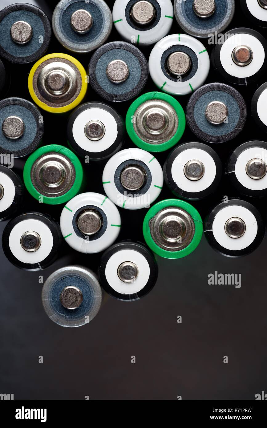 Many batteries on a metal table Stock Photo - Alamy