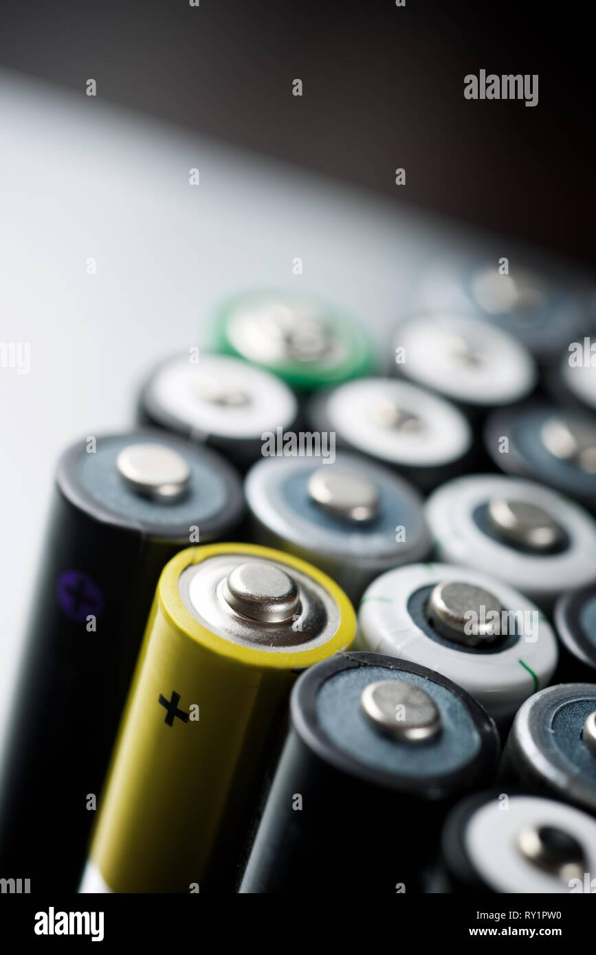 Many batteries on a metal table Stock Photo - Alamy