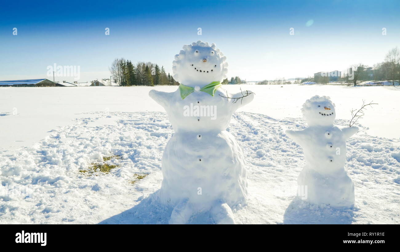 Two snowman on the wide white field. These cute snowman figures are ...