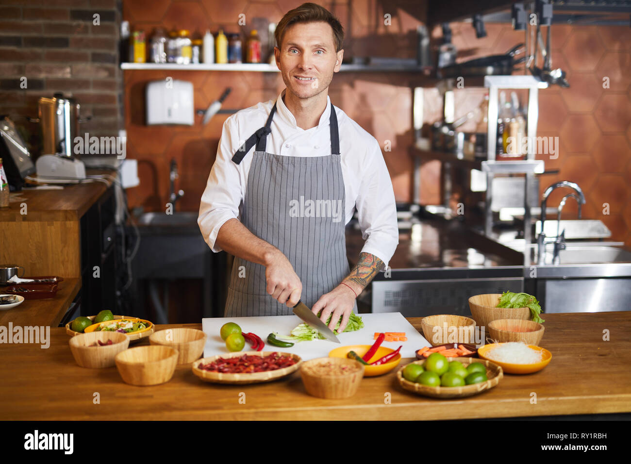Young male chef preparing hi-res stock photography and images - Alamy