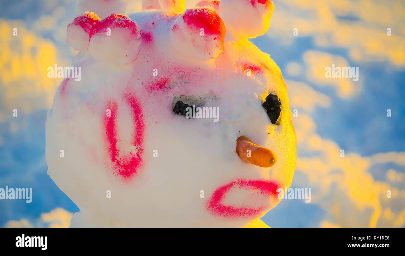 The lady snowman with spiked hair and red color paint all over the body ...