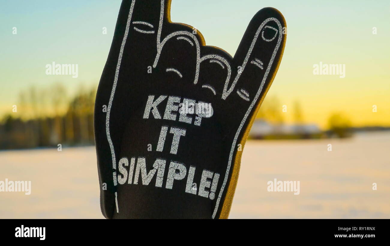 A hand sign with keep it simple phrase. It is a hand figure sign on the ...