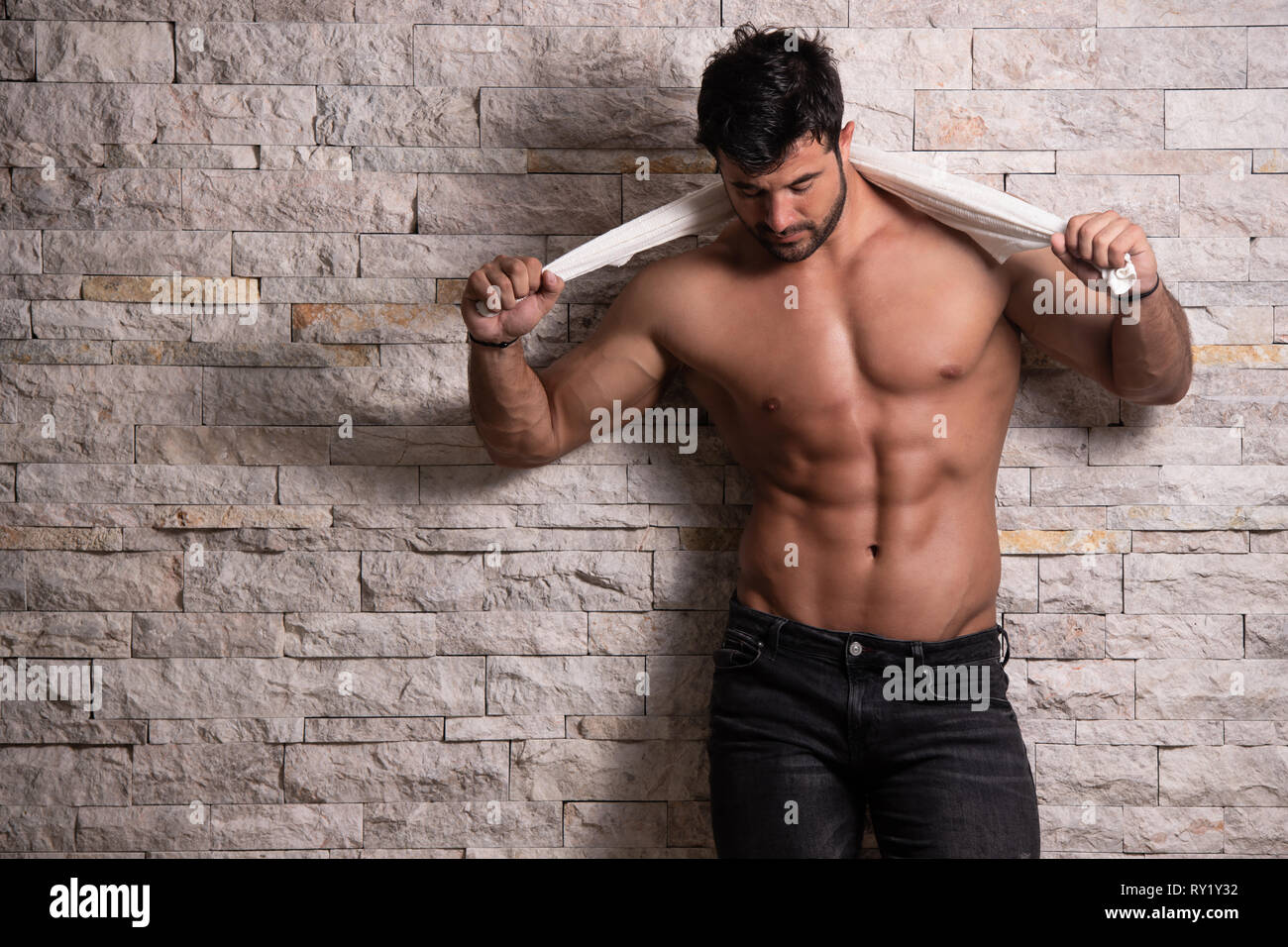 Healthy Young Man Standing Strong Against a Brick Wall and Flexing ...