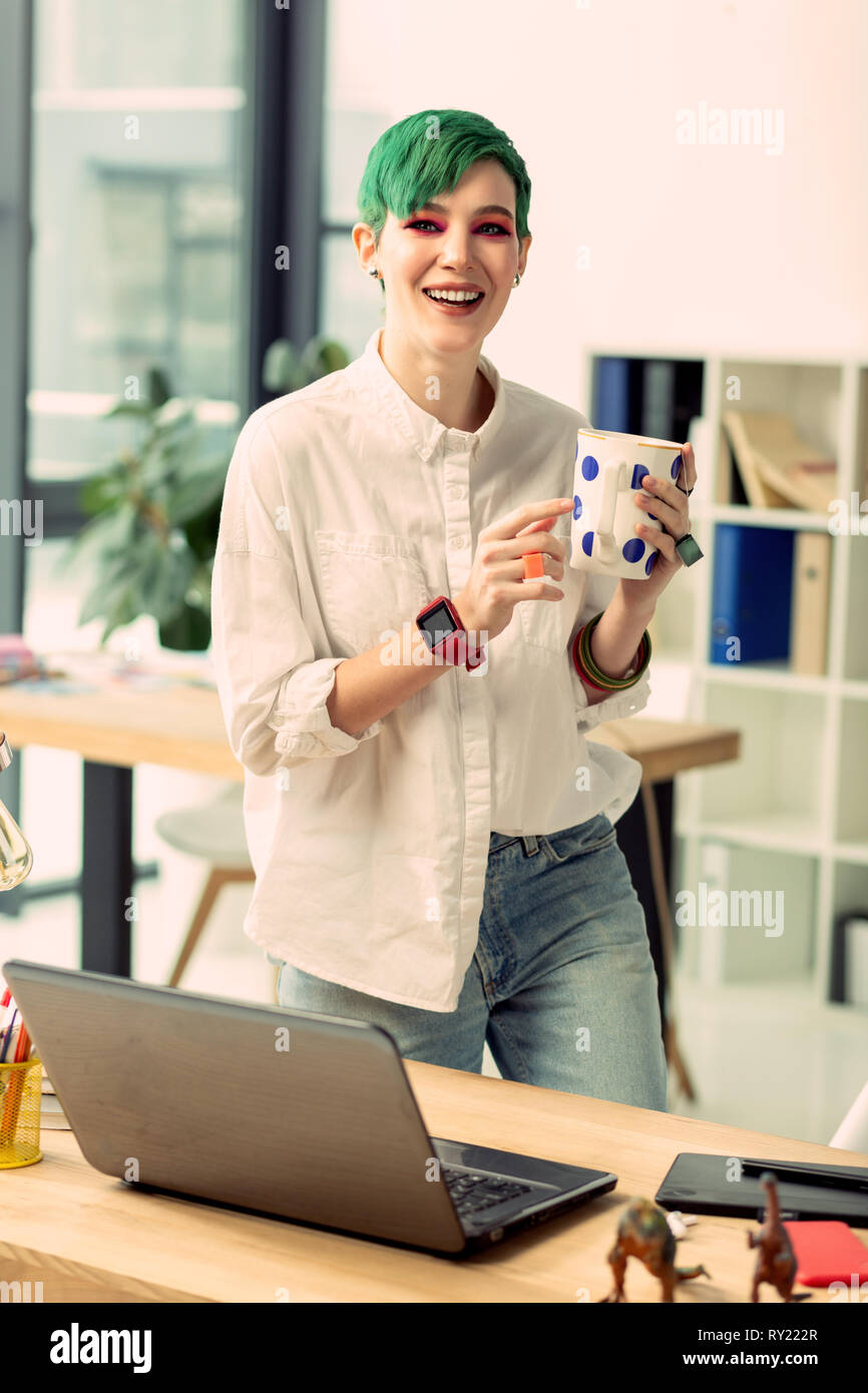 Positive delighted woman standing with a tea cup Stock Photo - Alamy