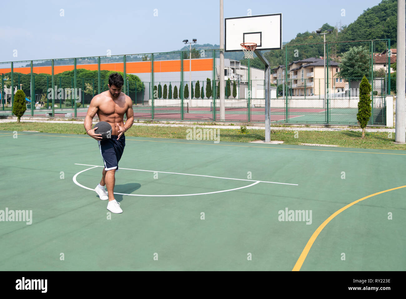 Basketball Player Bodybuilder Practicing And Posing For Basketball And ...