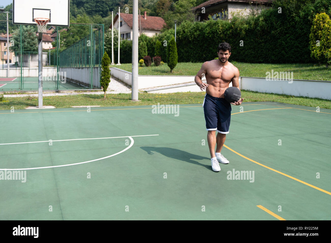 Basketball Player Bodybuilder Practicing And Posing For Basketball And ...