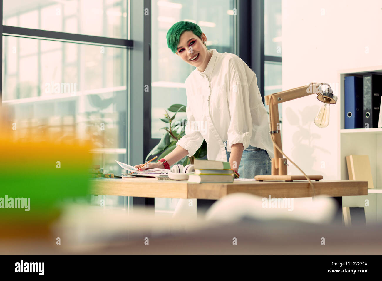 Nice good looking woman working on her own project Stock Photo - Alamy