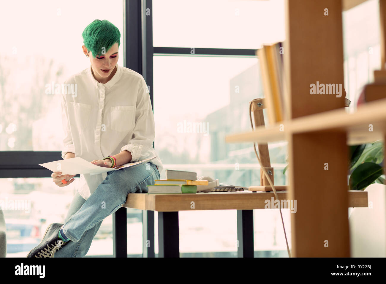 Pleasant hard working woman sitting in the office Stock Photo - Alamy