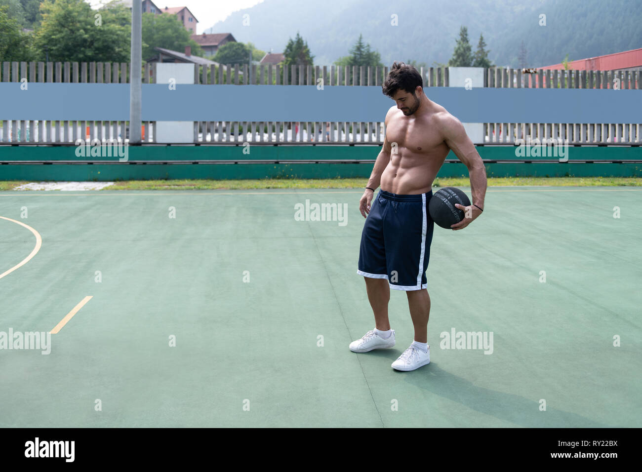 Basketball Player Bodybuilder Practicing And Posing For Basketball And ...