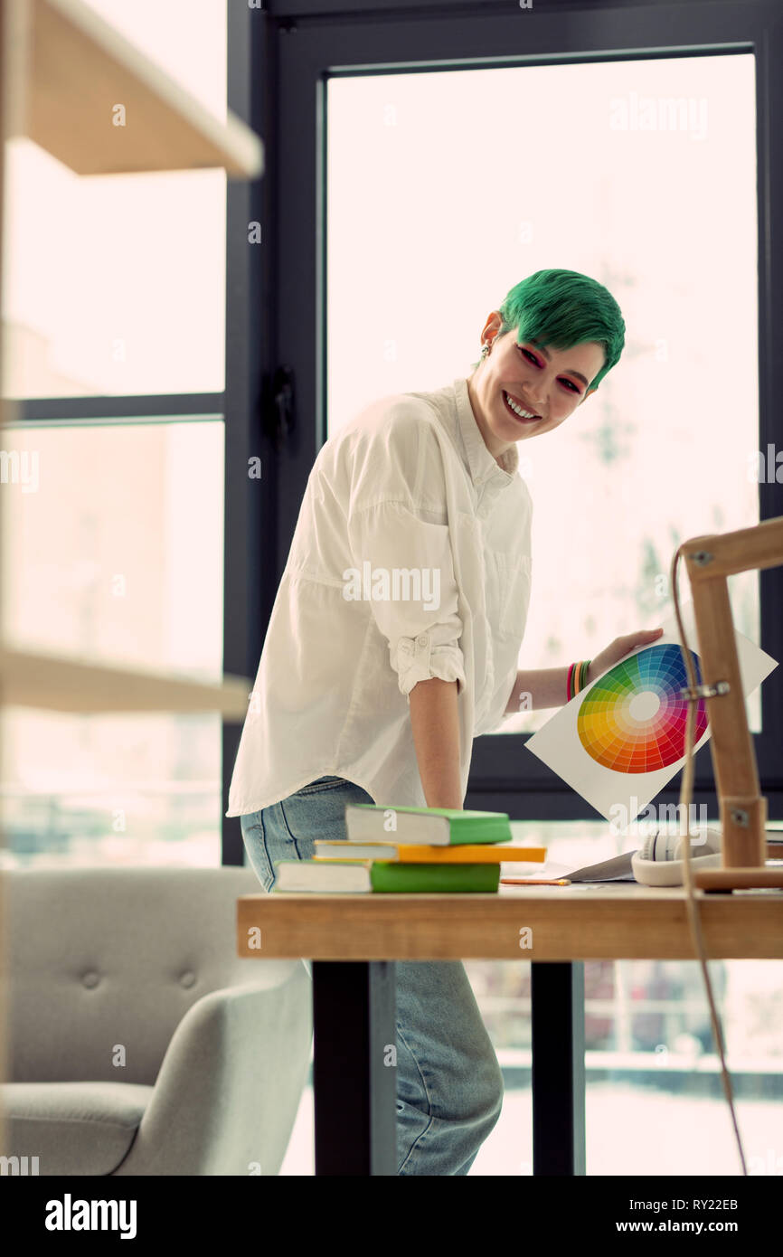 Nice joyful woman looking at the color wheel Stock Photo - Alamy