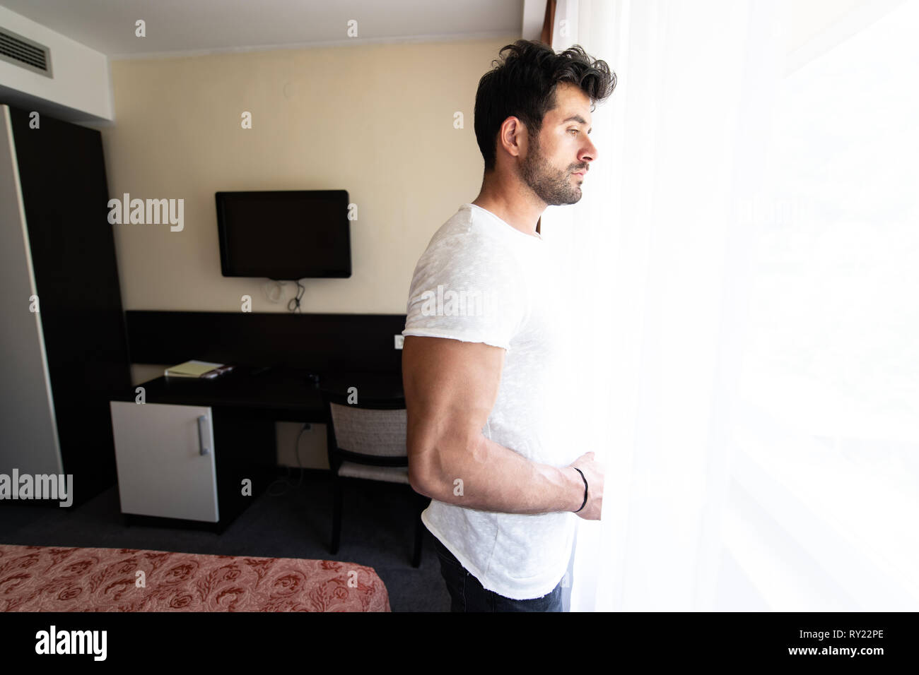 Guy looking through window hi-res stock photography and images - Alamy