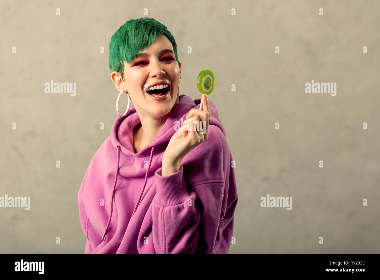 Beautiful woman holding lollipop hi-res stock photography and images ...