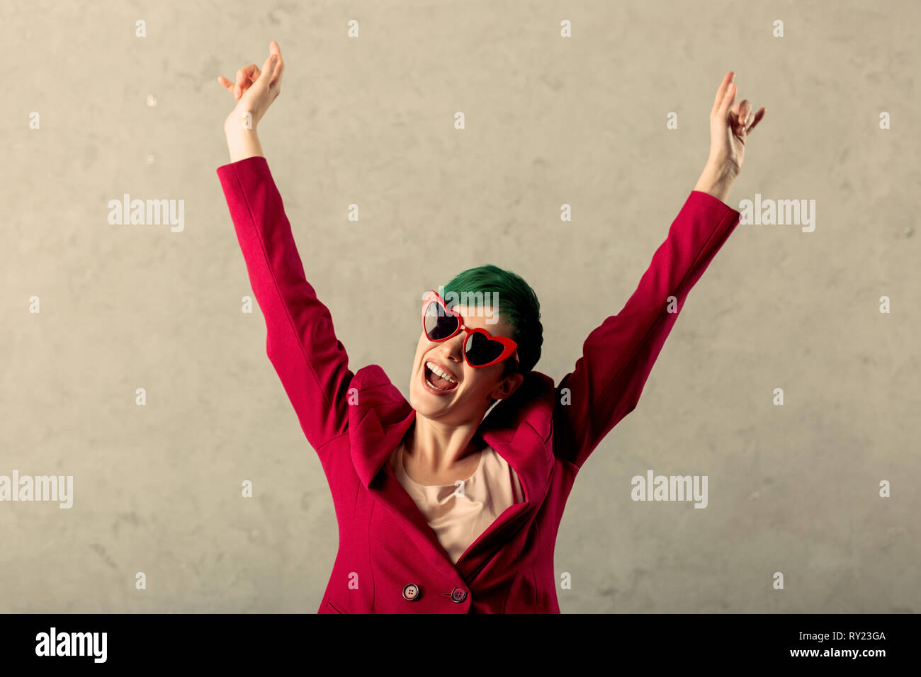 Nice happy woman holding her hands up Stock Photo - Alamy
