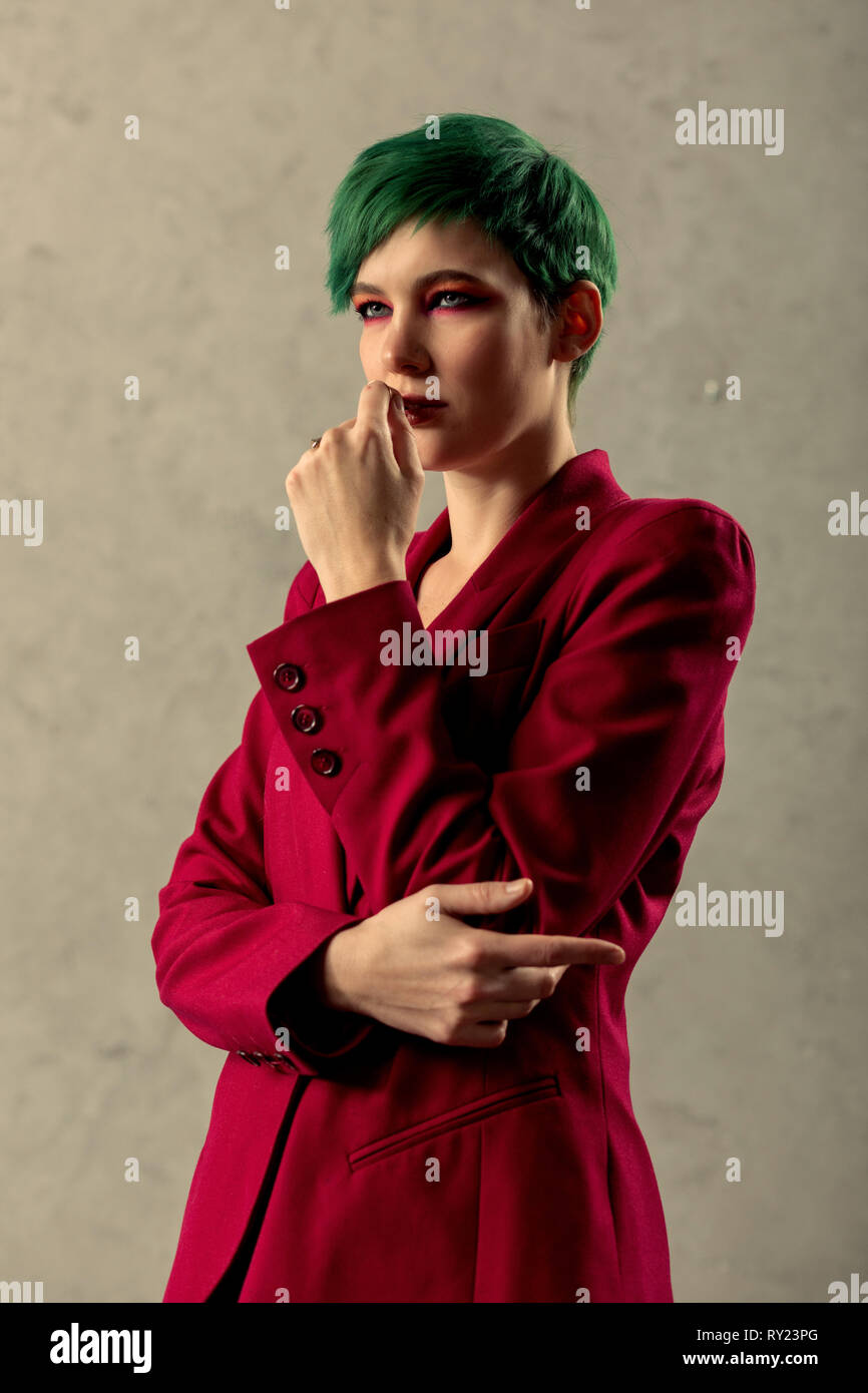 Nice green haired woman having a thoughtful look Stock Photo - Alamy