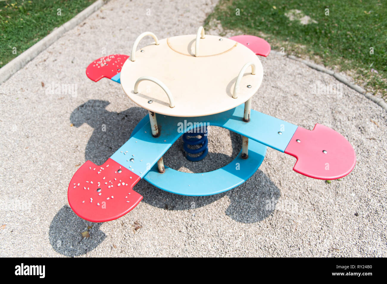 Colorful Carousel on a Playground in Sunlight Stock Photo - Alamy