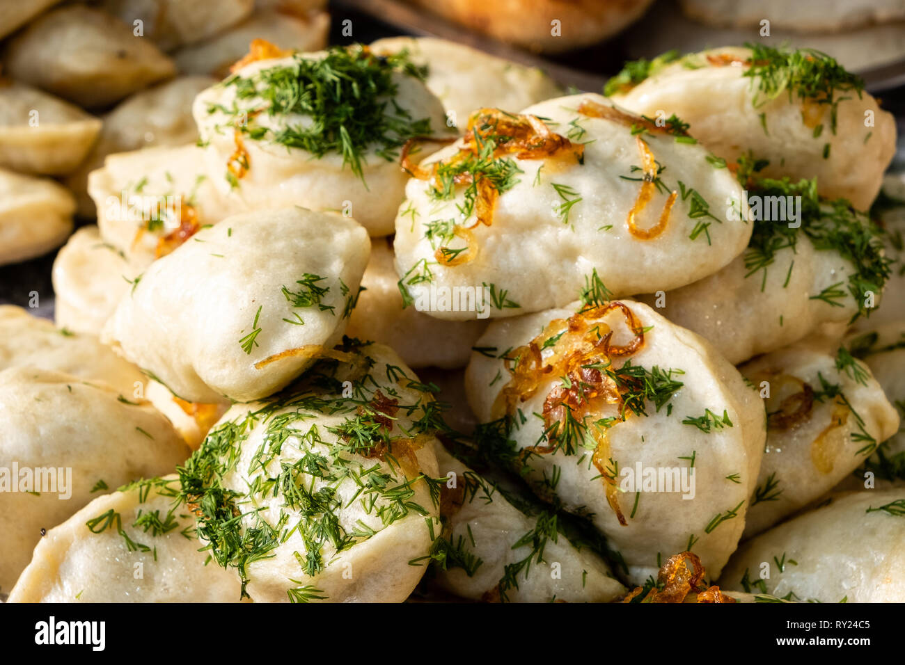Traditional Ukrainian dumplings with fried onions at the festival of ...