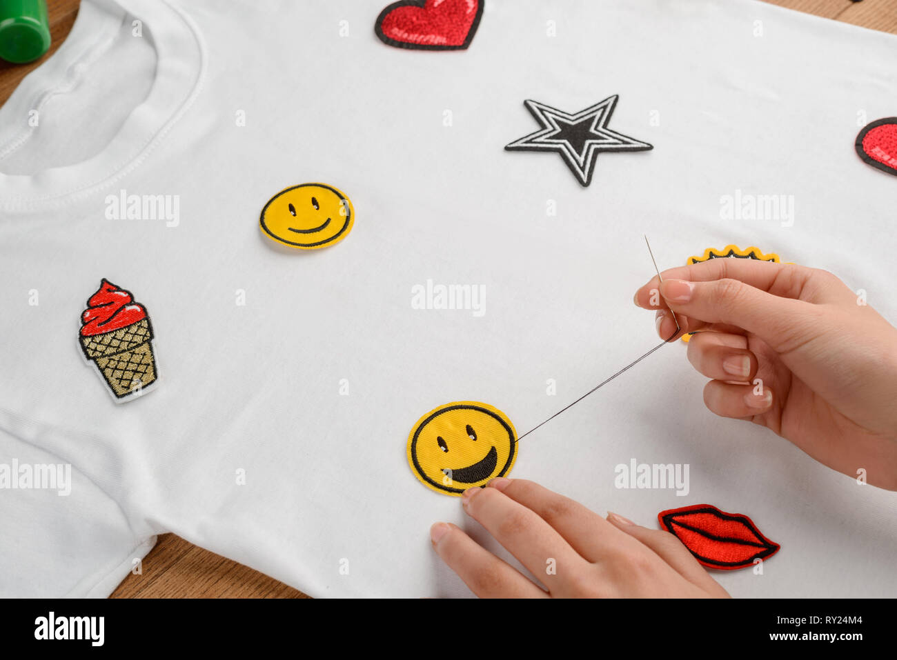 Woman sewing a patch Stock Photo - Alamy