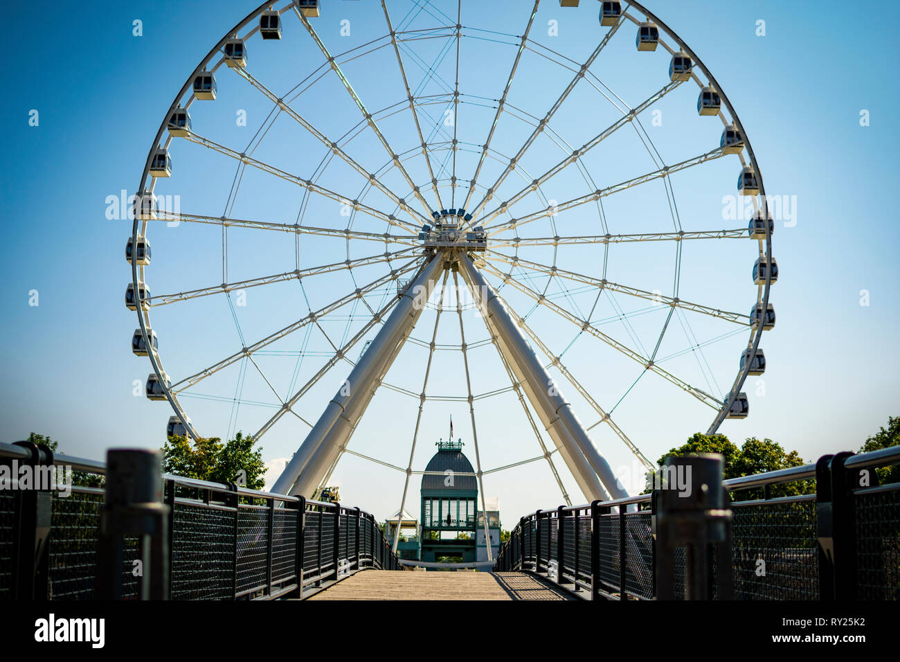 Big ferris wheel with a blue background with a deck Stock Photo - Alamy