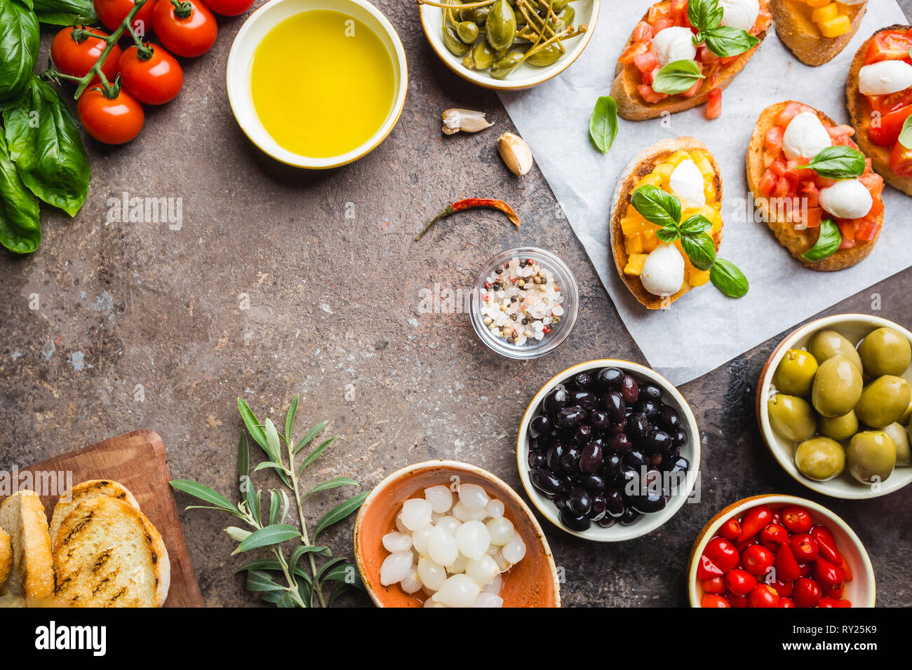 Italian appetizer from above. Mediterranean snack assortment. Black and ...