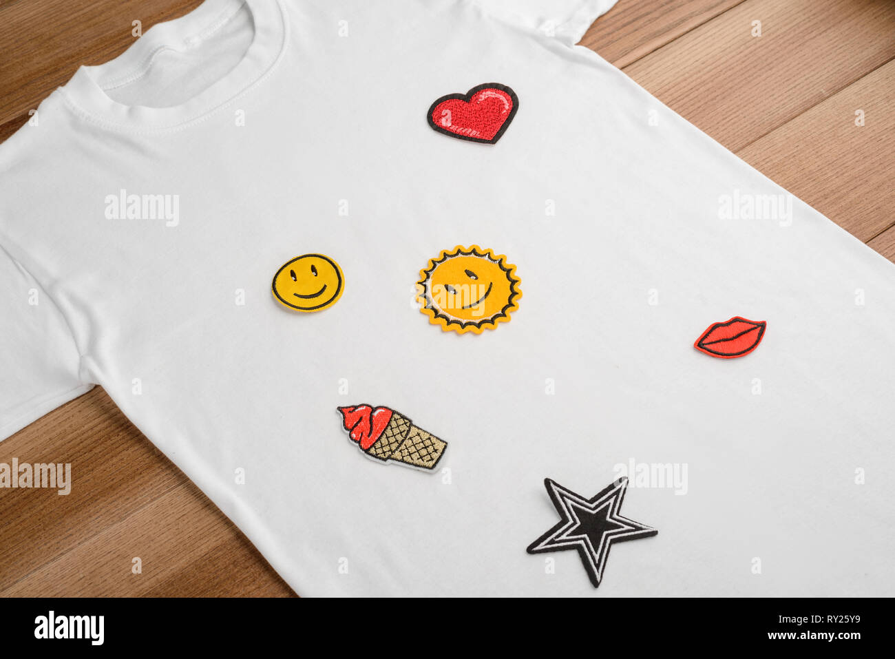 White t-shirt decorated with patches Stock Photo - Alamy