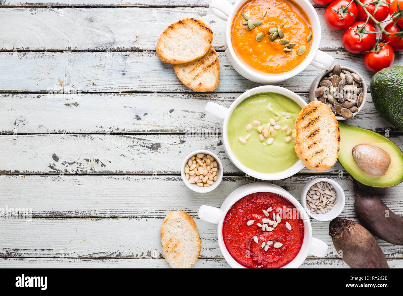 Variety of different colorful vegetable cream soups in a bowls, top ...