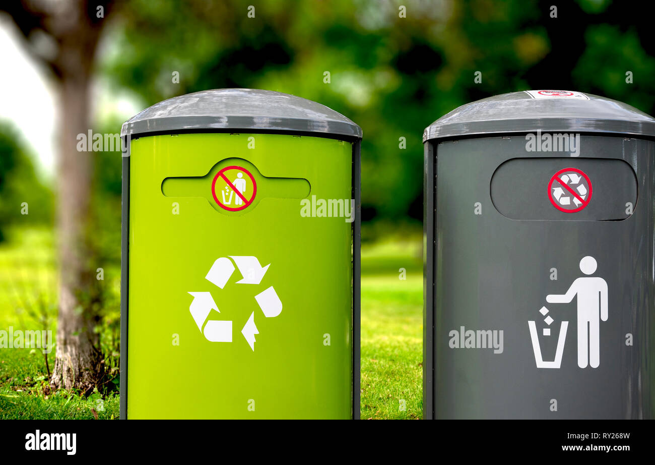 Green Recycle and a gary trash bins on focus with a blurred background ...