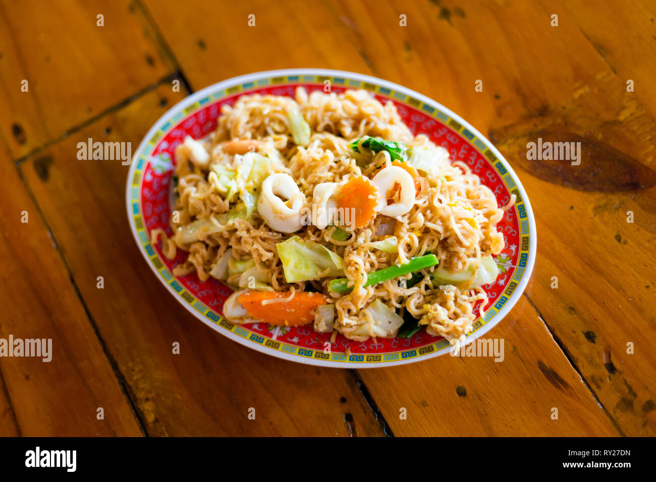 Fresh fried yellow noodle with squid and vegetables. Traditional thai ...