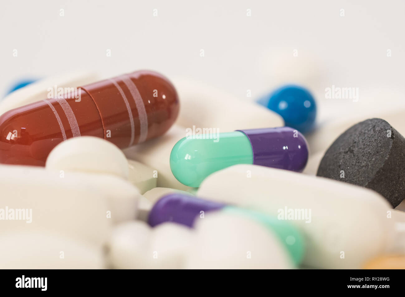 Macro picture of colored pills and drugs isolated on white background ...