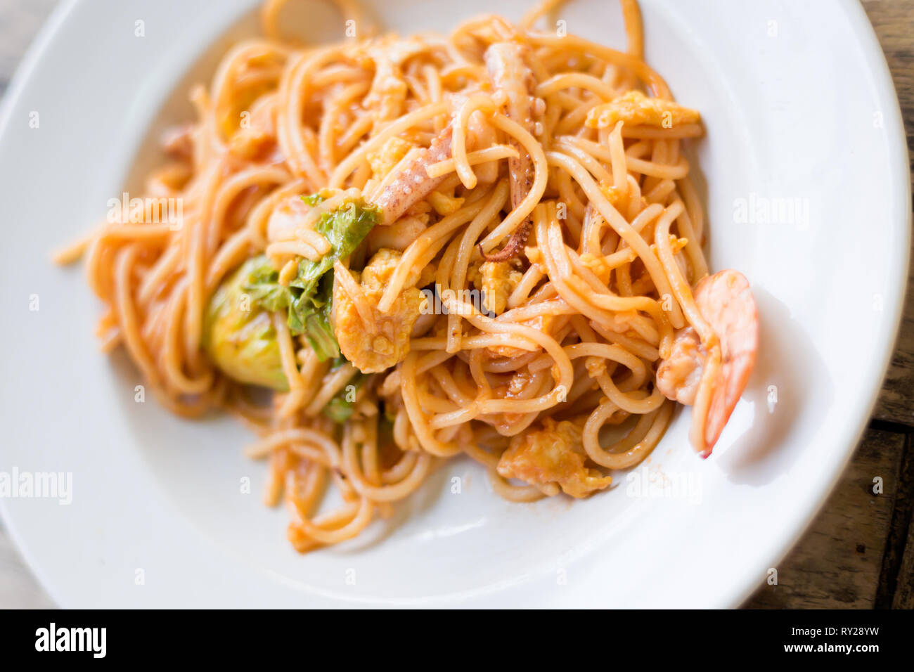 Fresh fried yellow noodle with prawns, squid and octopus. Traditional ...