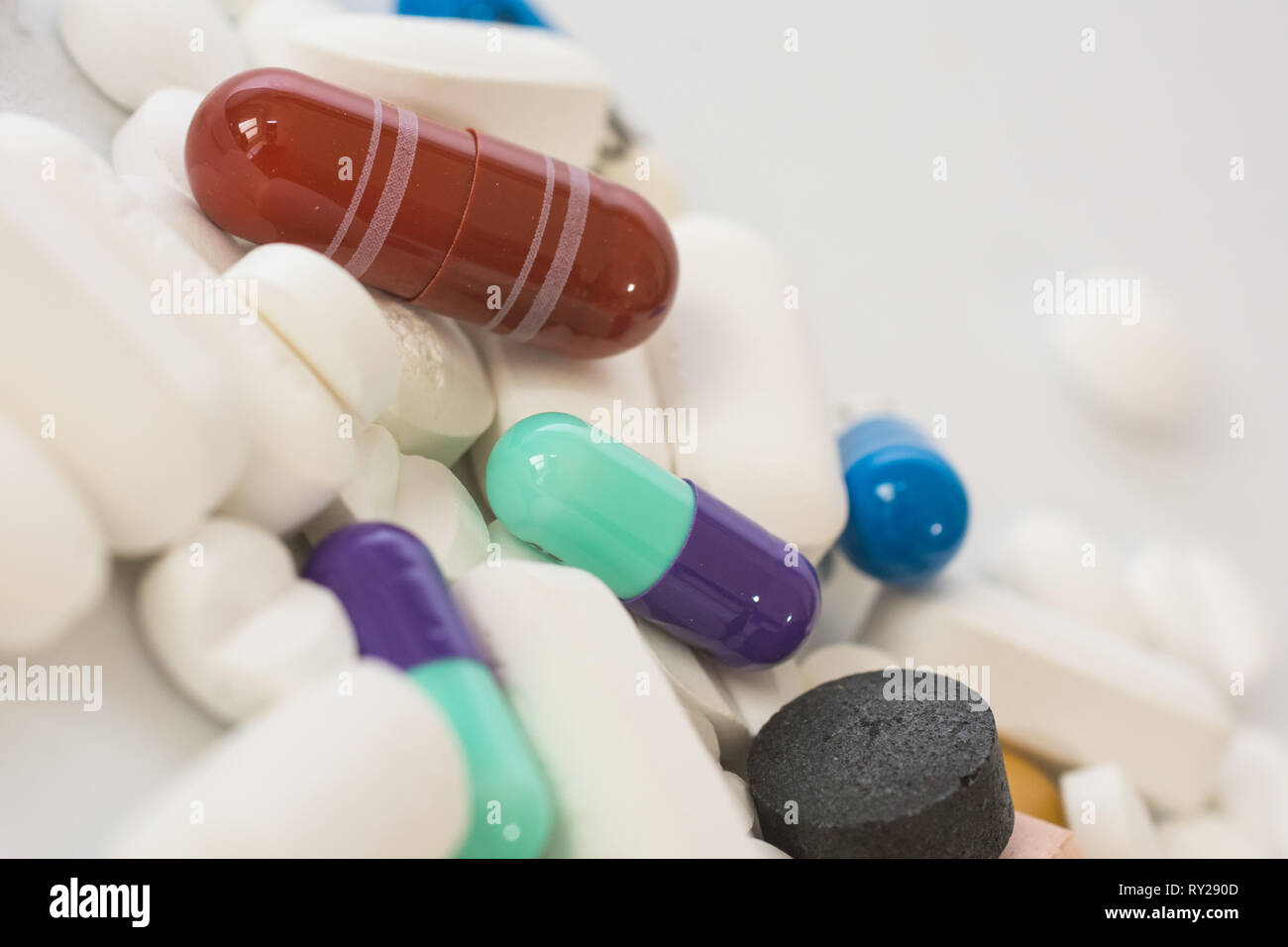 Macro picture of colored pills and drugs isolated on white background ...