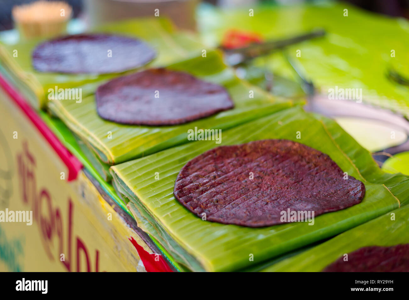 Fresh prepared asian black sticky rice pancake on banan leaf ...