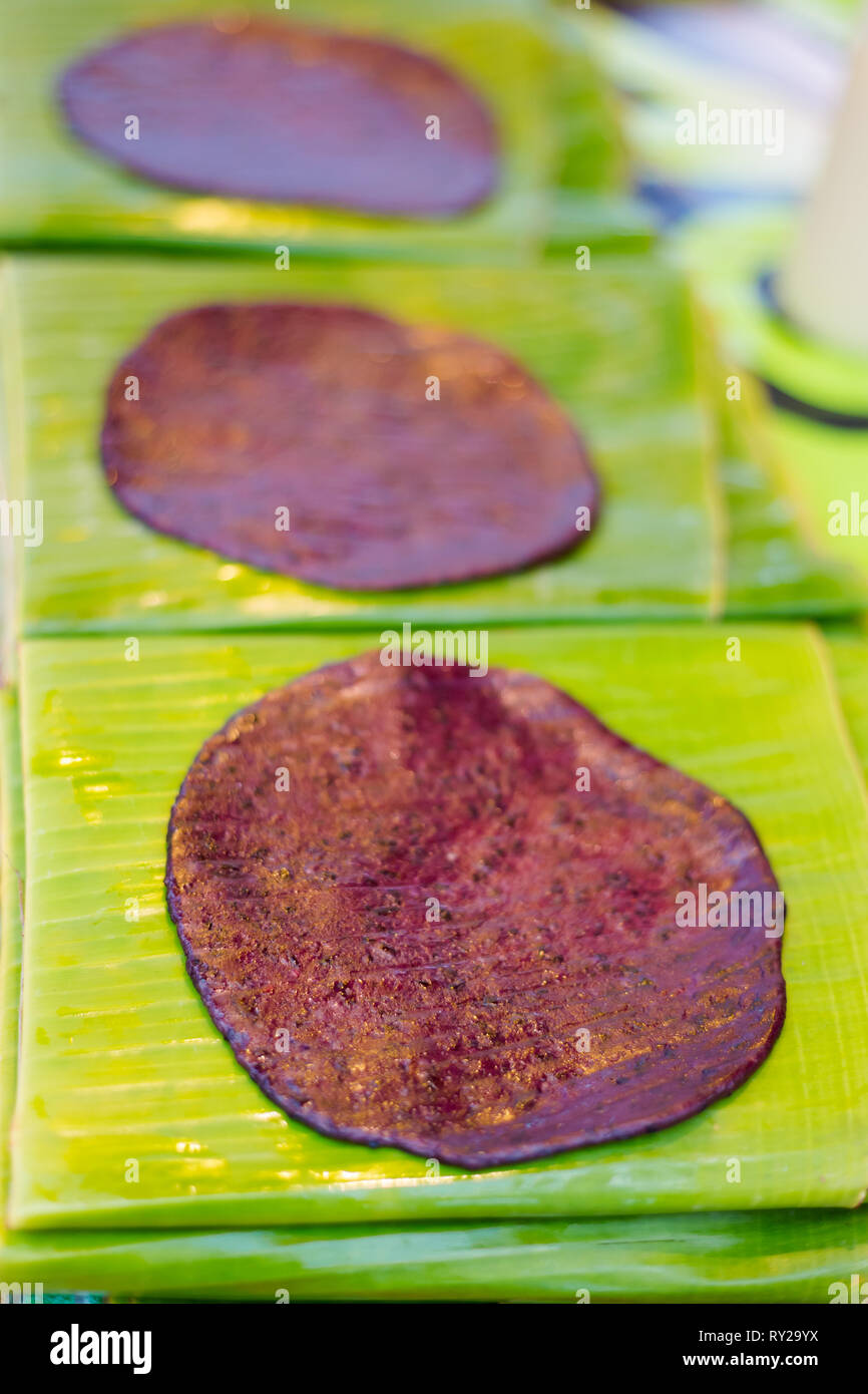 Fresh prepared asian black sticky rice pancake on banan leaf ...