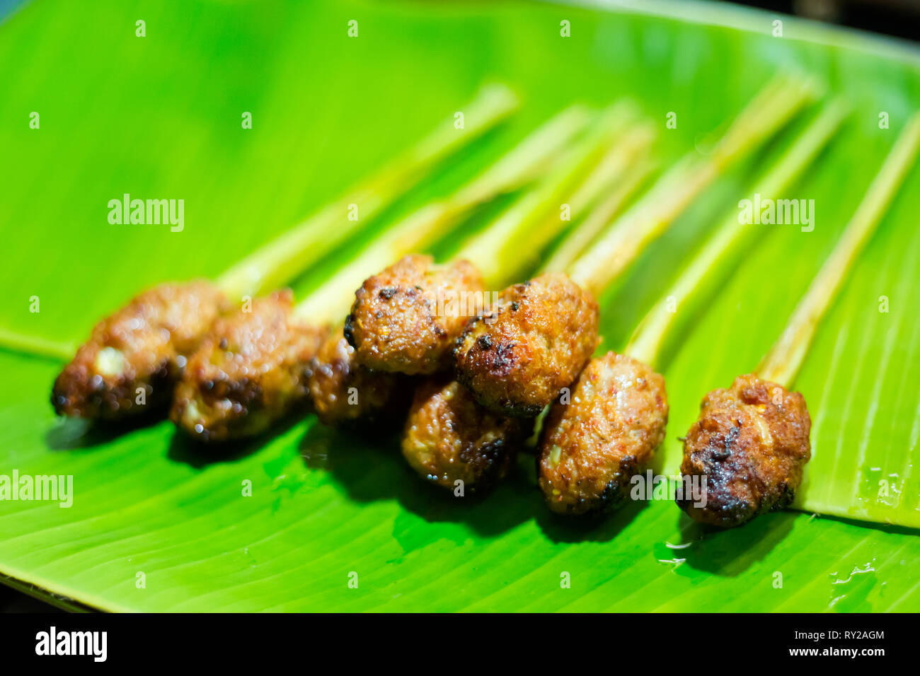 Fresh prepared asian mince pork meat stay made of lemon grass skewer ...