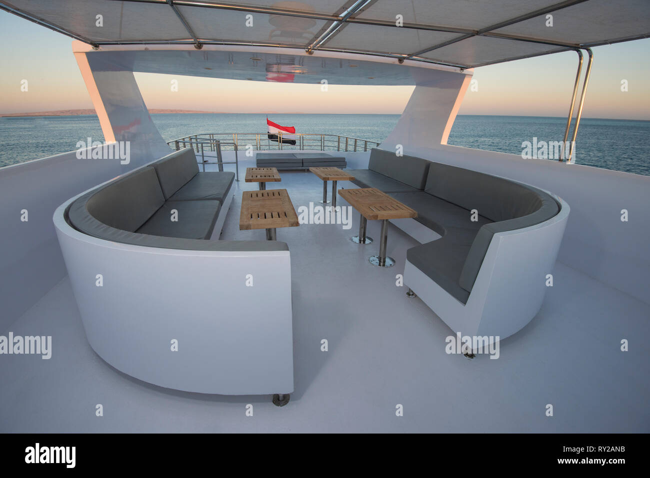 Sundeck area of a large luxury motor yacht with chairs sofa table and ...