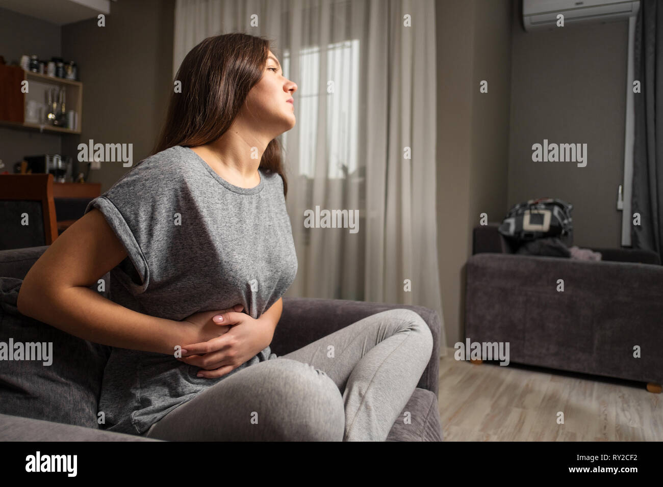 young woman has pain in right hypochondrium, stomachache, gallbladder ...